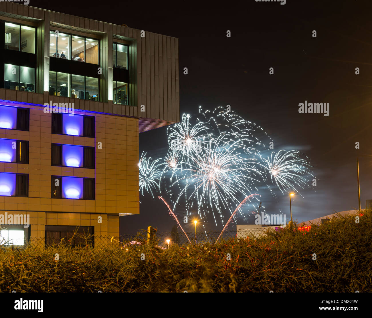 Hotel building at night lit up with people working late in offices and ...