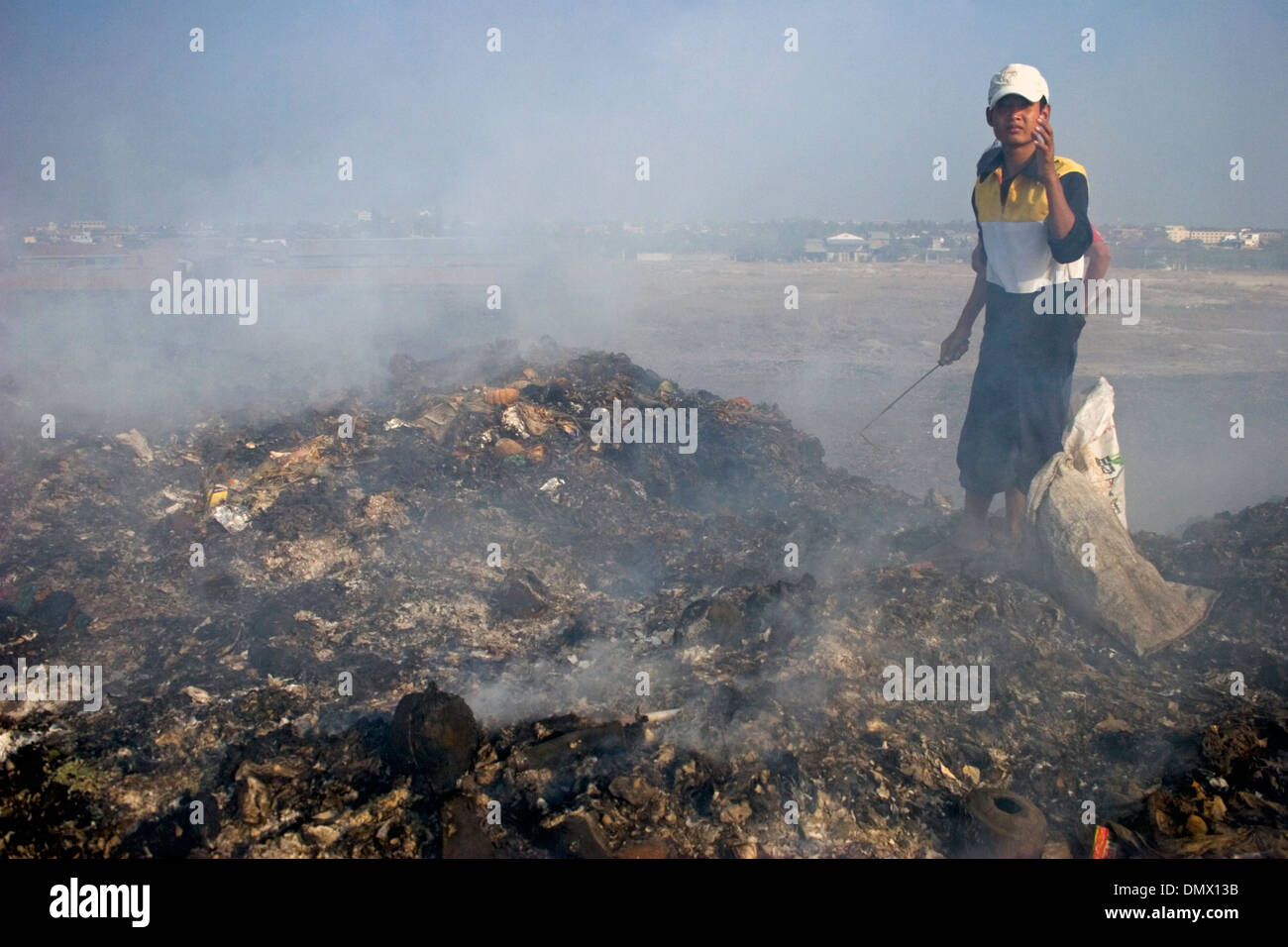 A young child laborer boy is collecting recyclable material at the ...