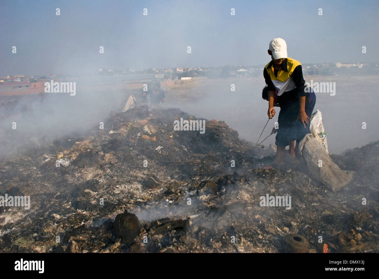 A young child laborer boy is collecting recyclable material at the ...