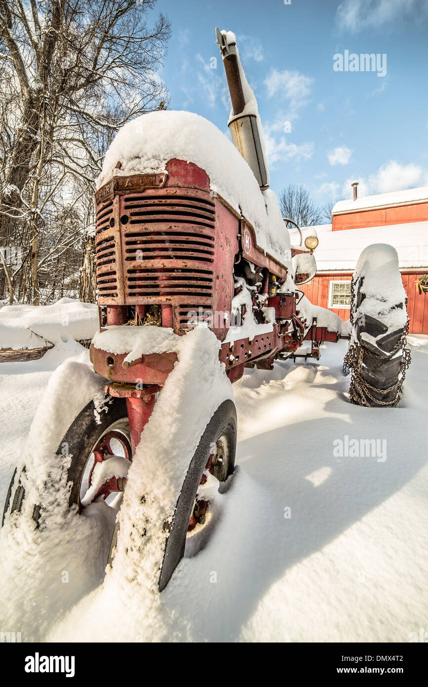 An old farm tractor covered in fresh winter snow Stock Photo - Alamy