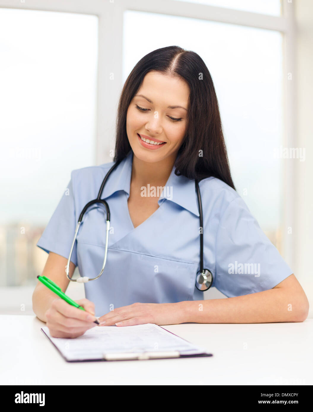 female doctor or nurse writing prescription Stock Photo - Alamy