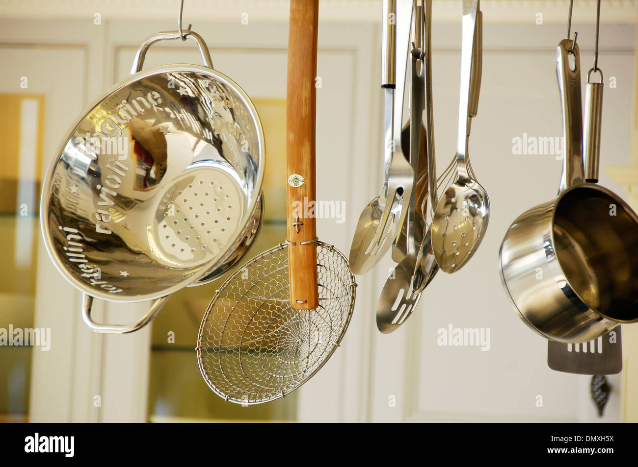 Kitchen utensils hanging up in a modern kitchen Stock Photo - Alamy
