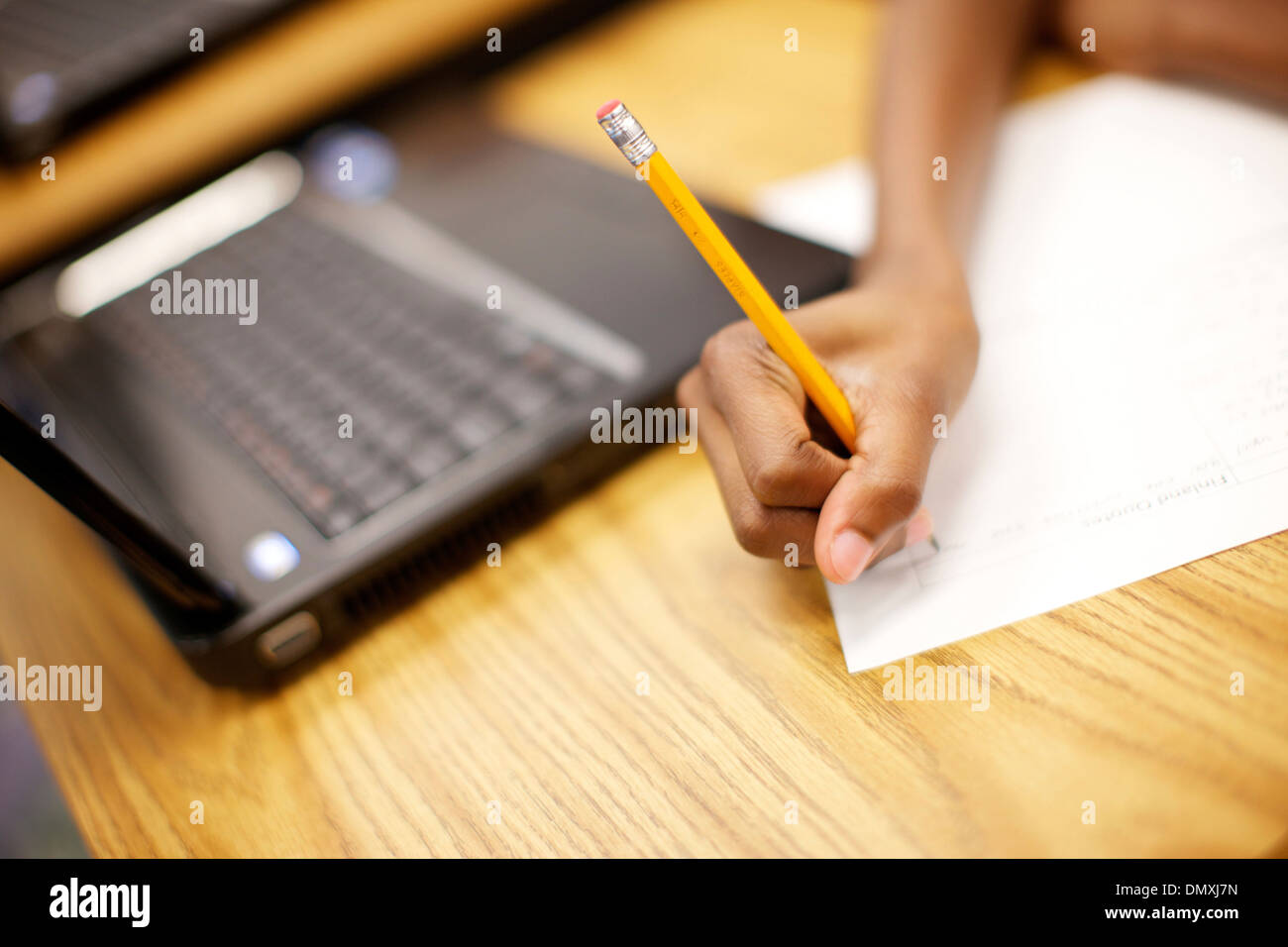 Close up shot of a boys hand writing with a pencil in class Stock Photo ...