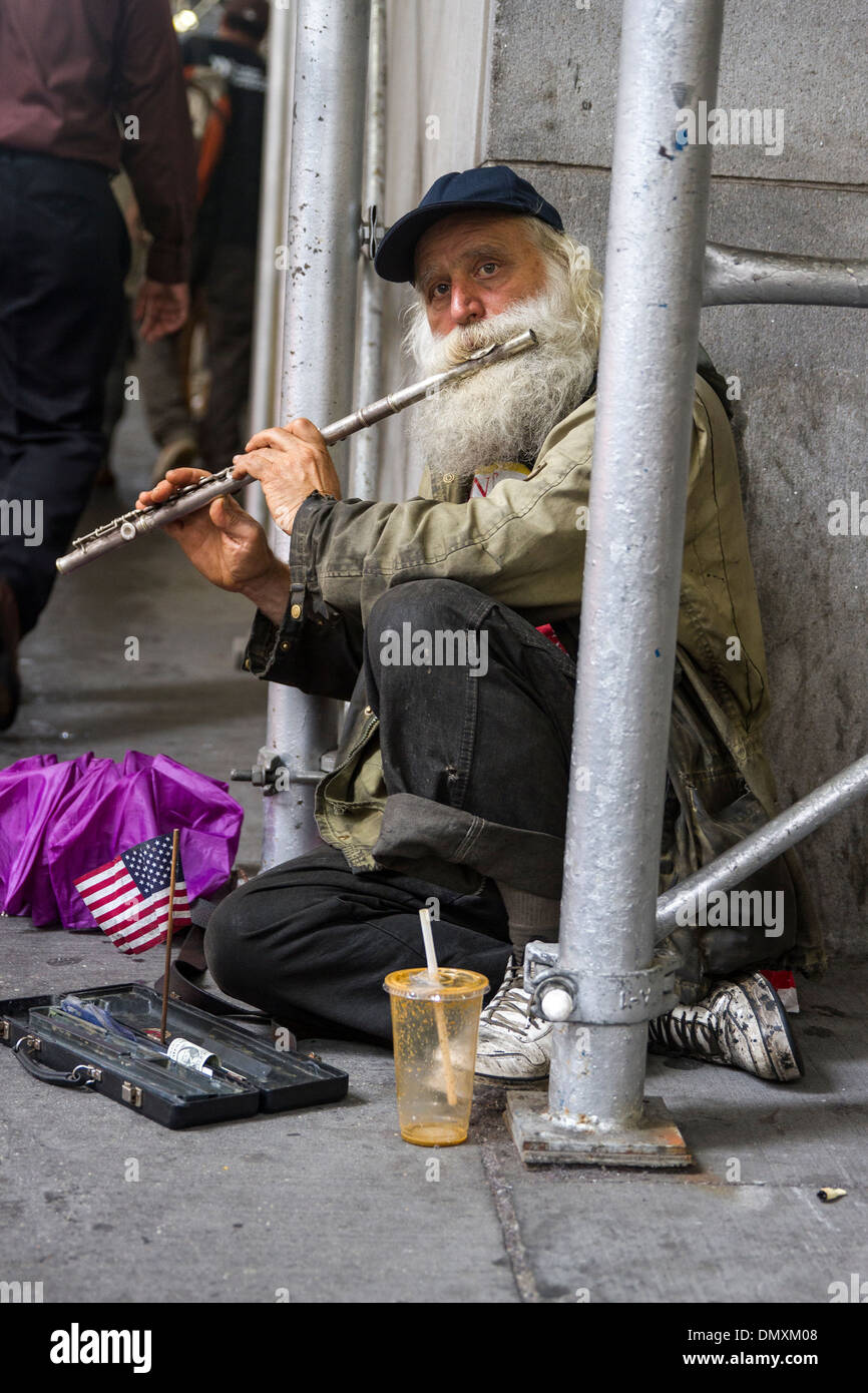 Street musician playing flute busking hi-res stock photography and ...