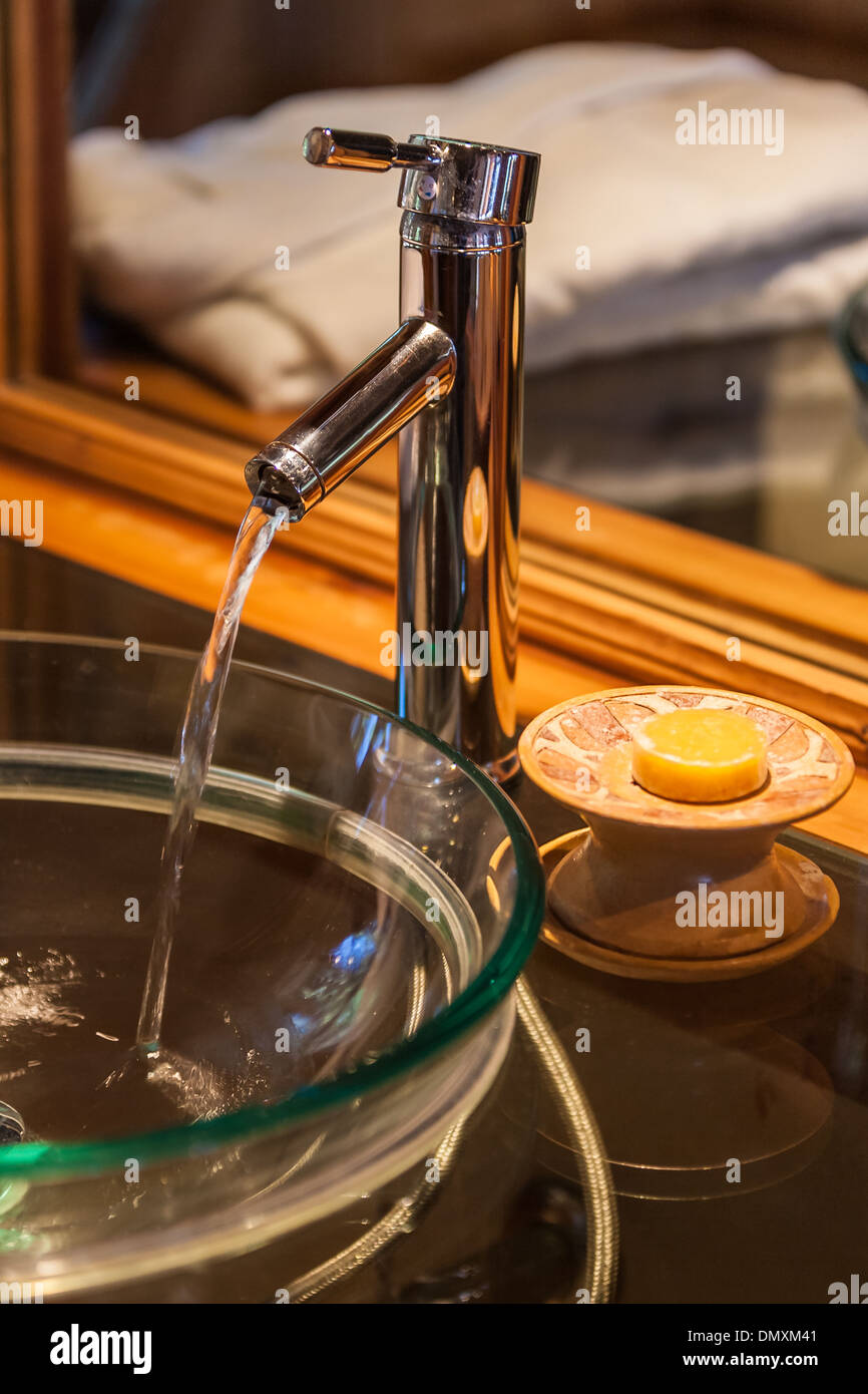 Tap flowing in a luxurious hotel room bathroom Stock Photo - Alamy