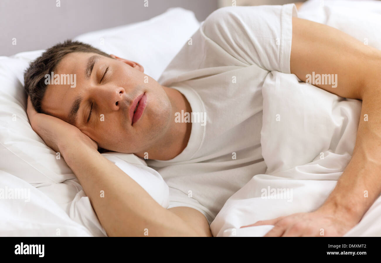 handsome man sleeping in bed Stock Photo - Alamy