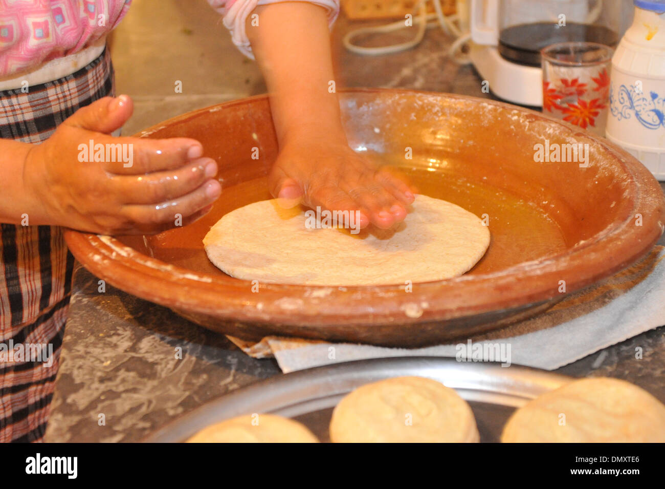 Woman cooking Arab bread at home Stock Photo - Alamy