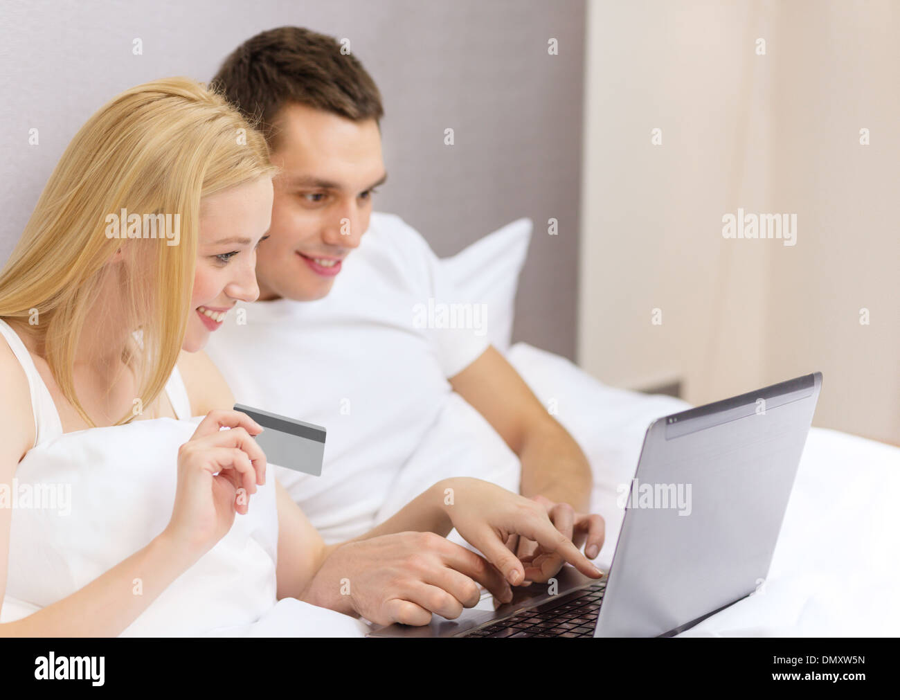 couple in bed with laptop computer and credit card Stock Photo - Alamy