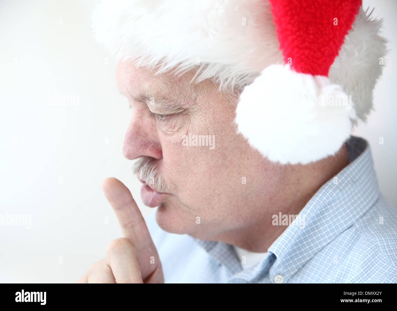 older man makes a shushing gesture with his index finger Stock Photo ...