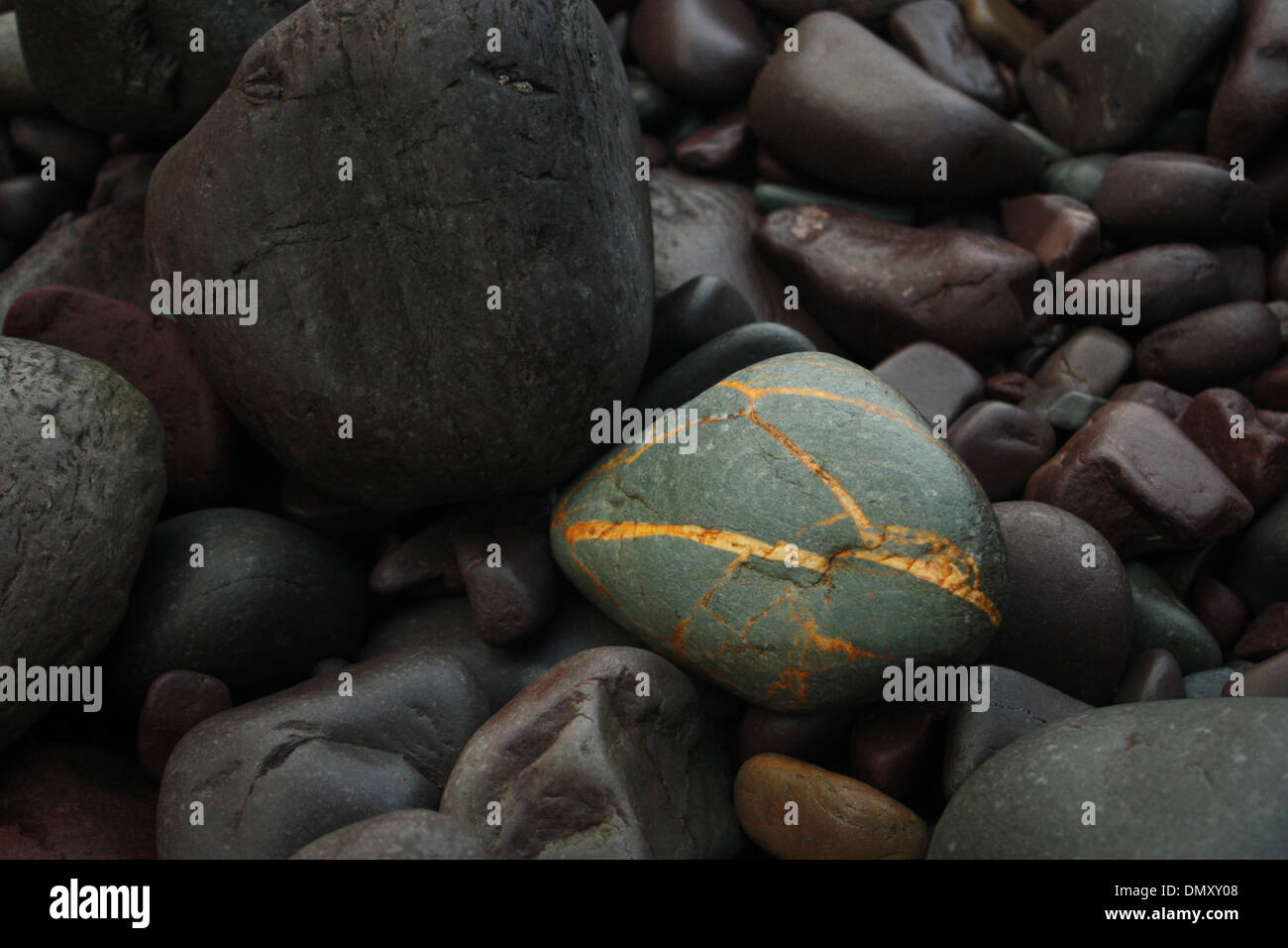 Orange-Striped Rock on Beach Stock Photo - Alamy