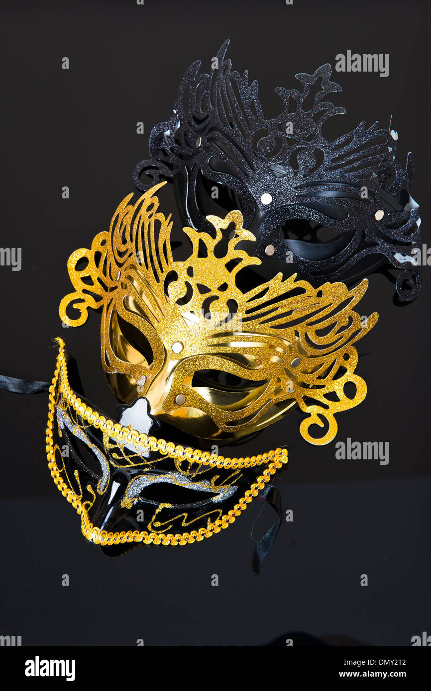 three venetian masks on a black background Stock Photo - Alamy