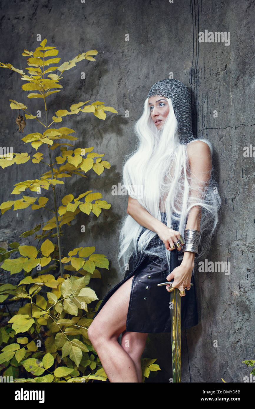 Attractive gray-haired maiden warrior in armor with sword in hand Stock ...