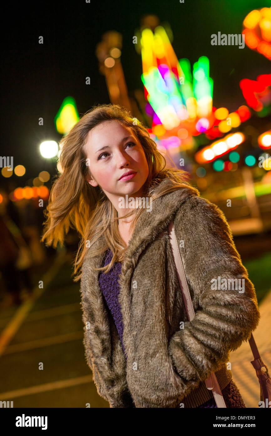 A Teenage girl young woman enjoying herself at the funfair fairground ...