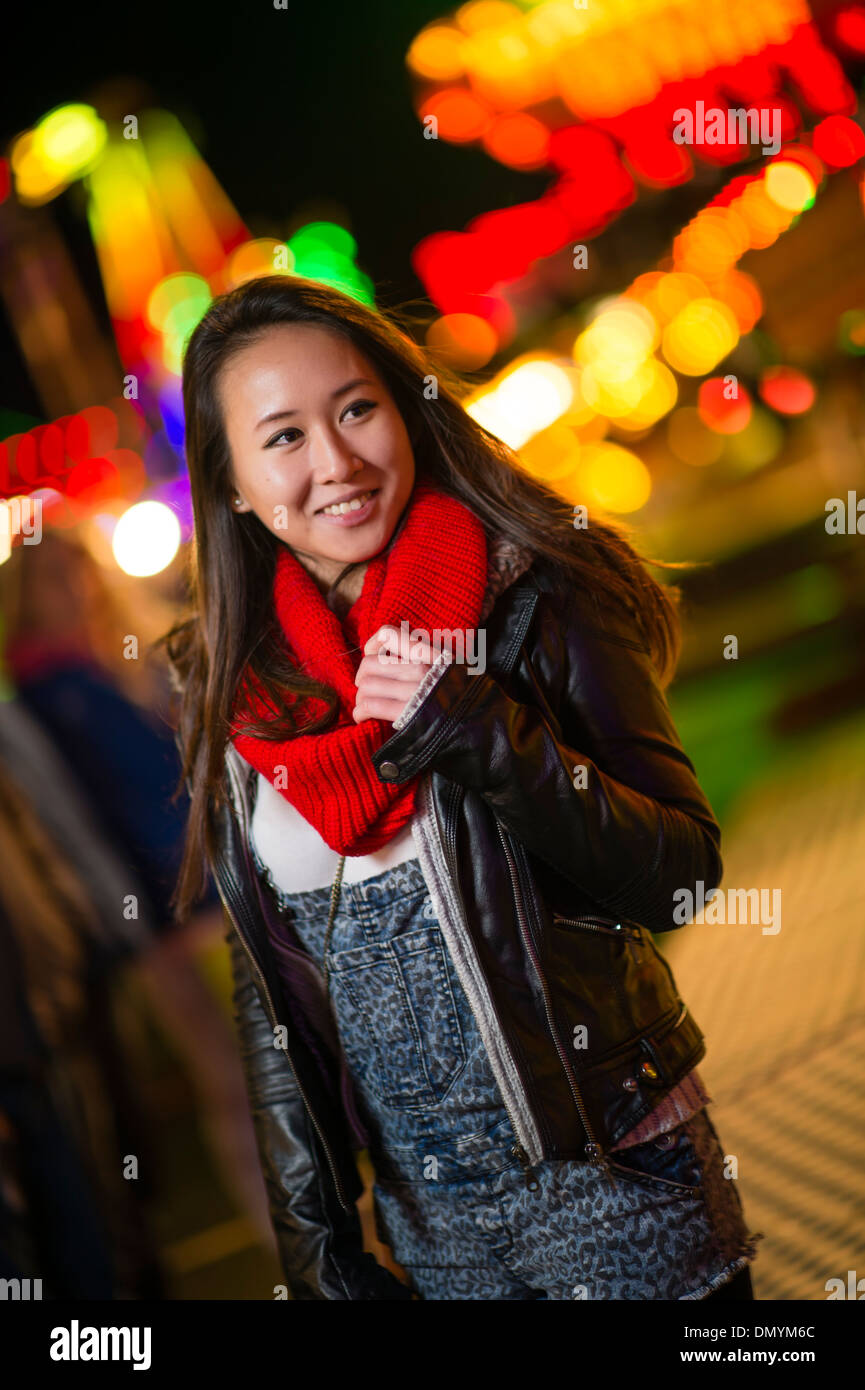 A Teenage girl young Chinese woman enjoying herself at the funfair ...