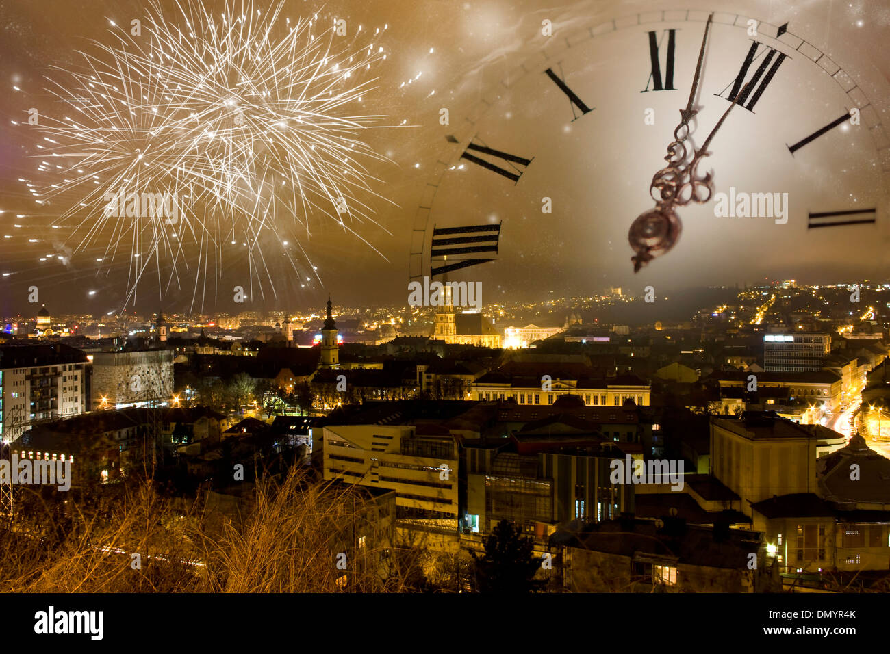 Holiday fireworks and clock close to midnight over the city Stock Photo ...