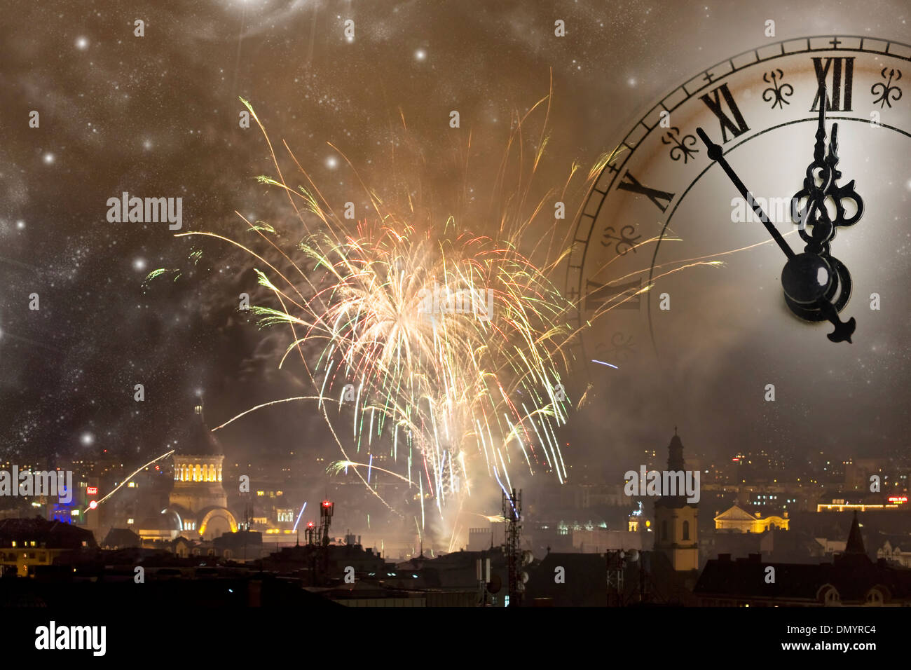 Holiday fireworks and clock close to midnight over the city Stock Photo ...