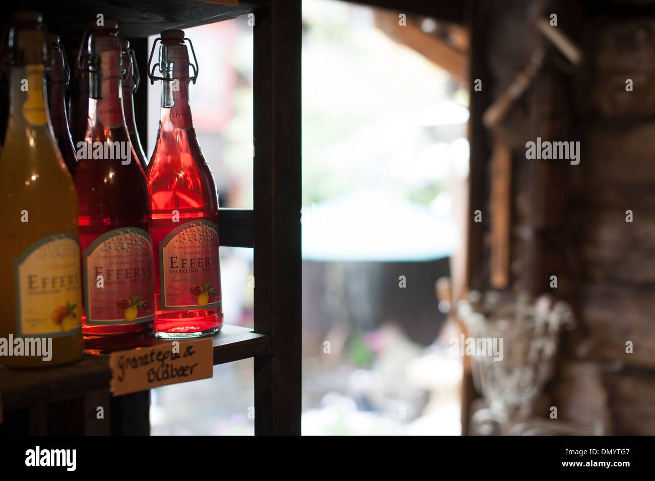Tree bottles of apple cider on display on a sales stand in a shop in ...
