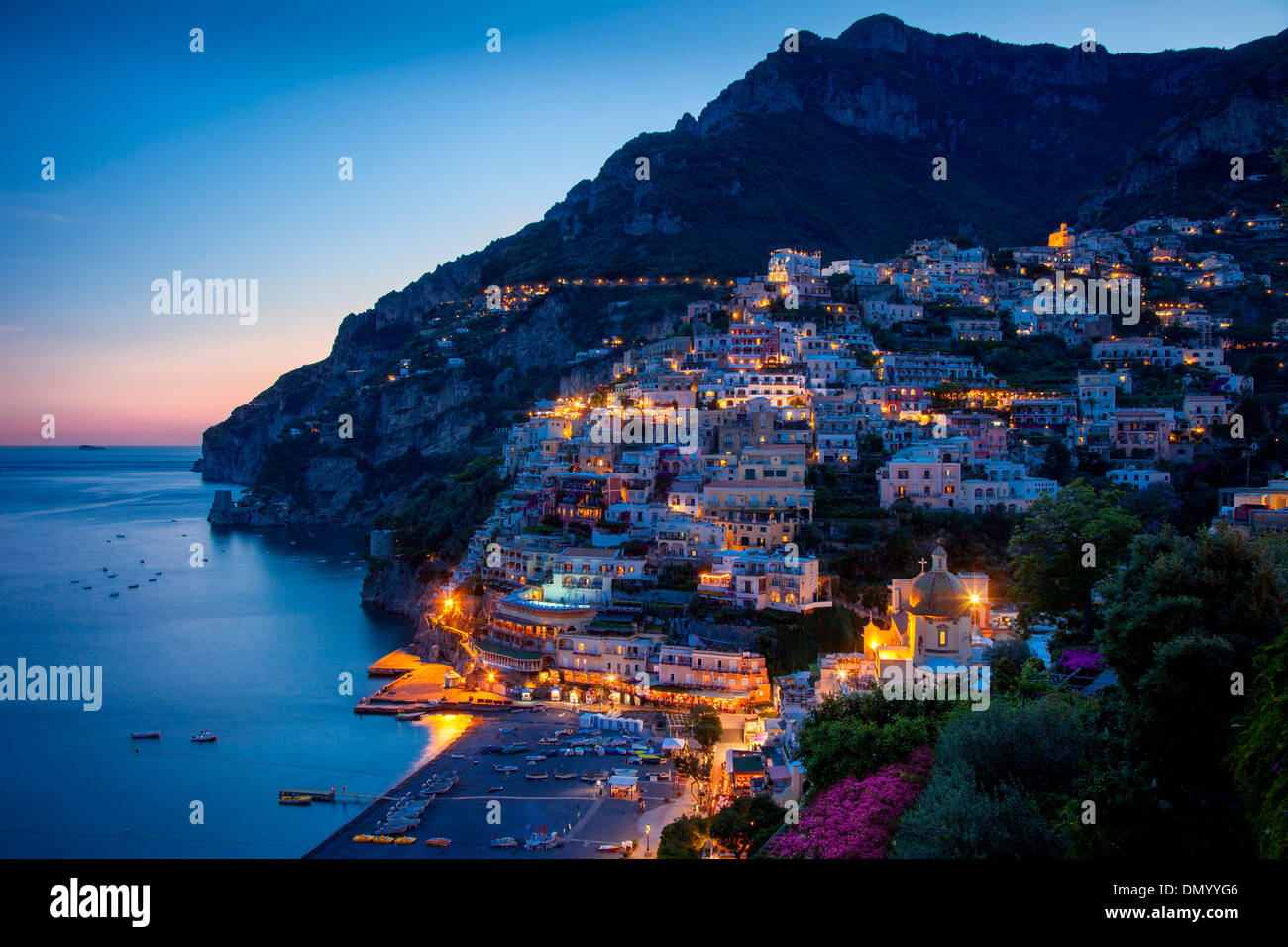 Evening view along the Amalfi coast of the hillside town of Positano ...