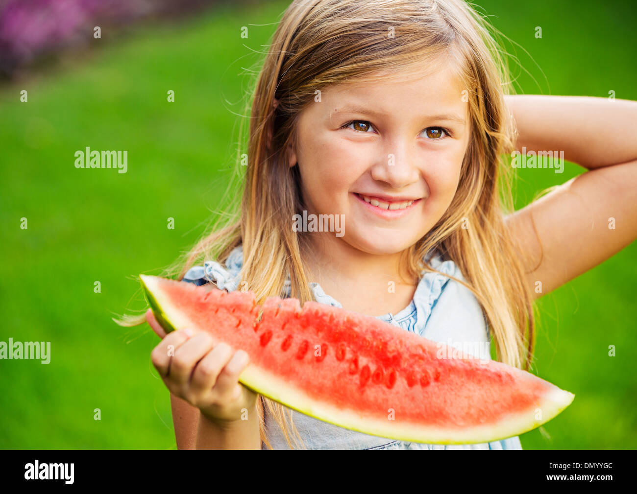 Cute little girl eating watermelon Stock Photo - Alamy