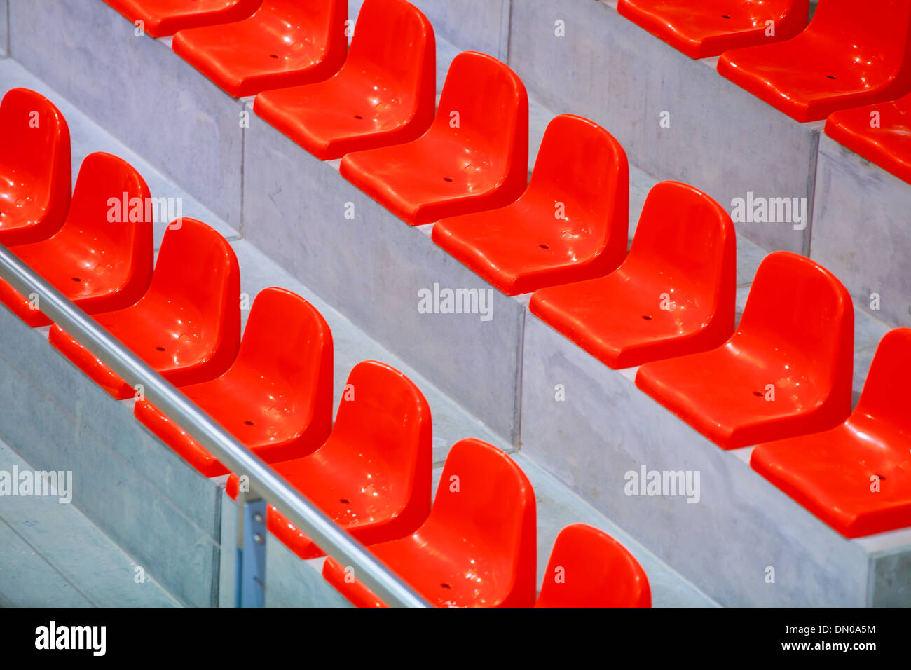 Closeup of red sport stadium seats. Empty stand. Team sport and ...