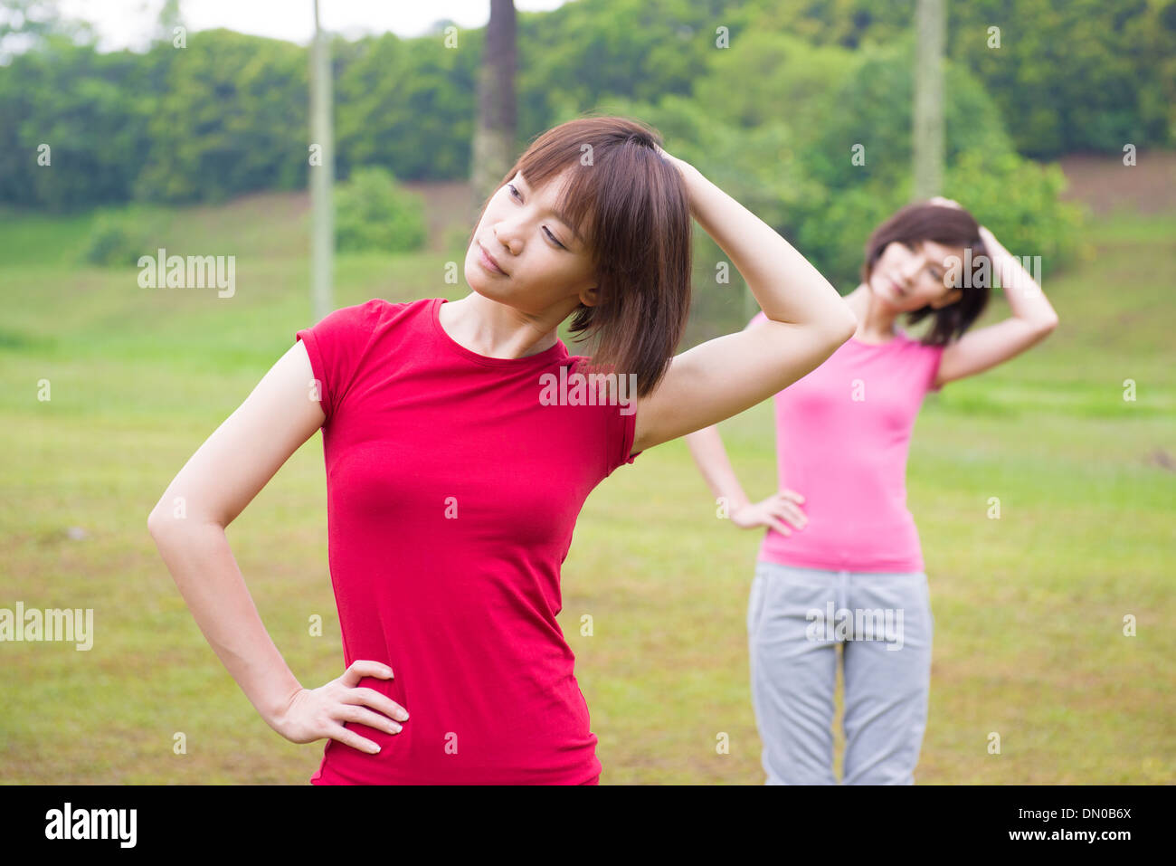 Asian Chinese girls workout outdoor, stretching Stock Photo - Alamy