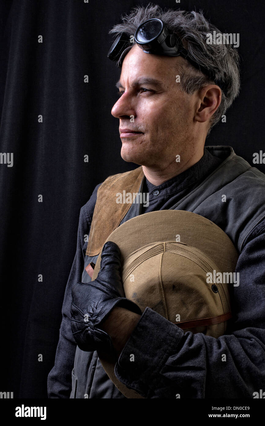 A steam punk airship captain staring off at his next destination with ...