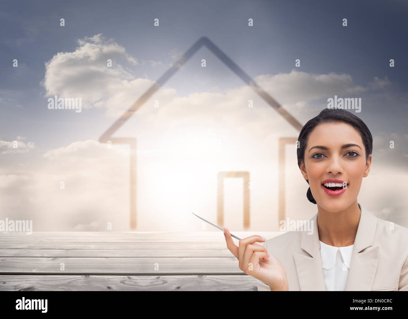 Composite image of smiling businesswoman holding a pen Stock Photo - Alamy