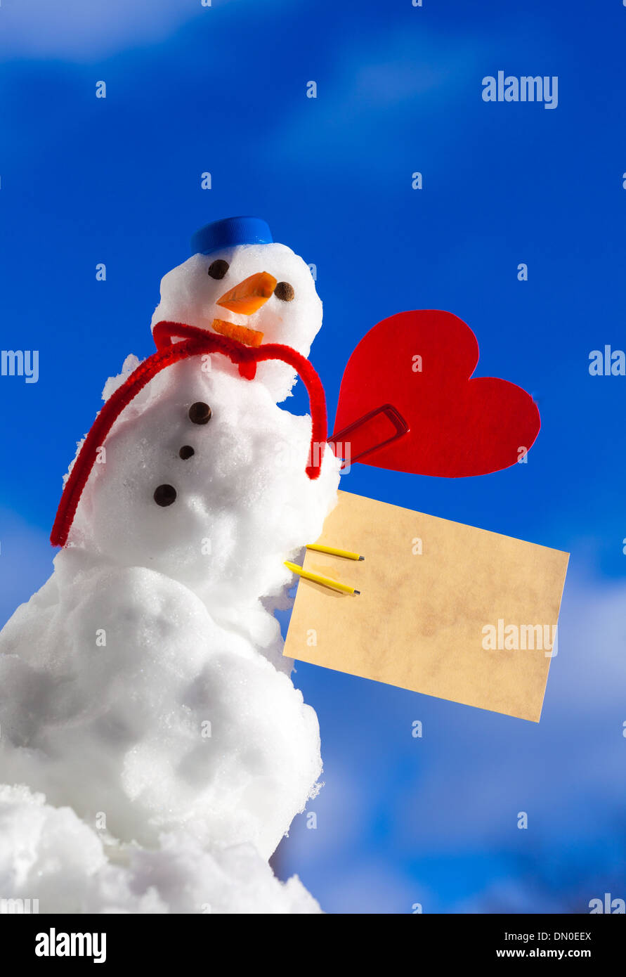 Happy snowman with red heart love symbol and paper card blank copyspace ...