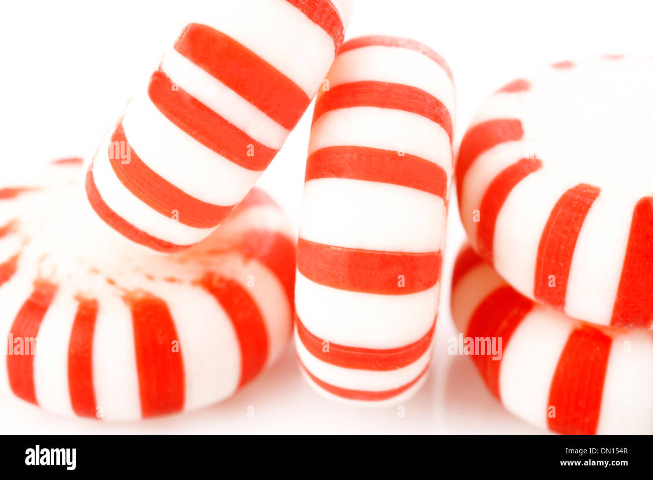 Red striped peppermints on a white background Stock Photo - Alamy