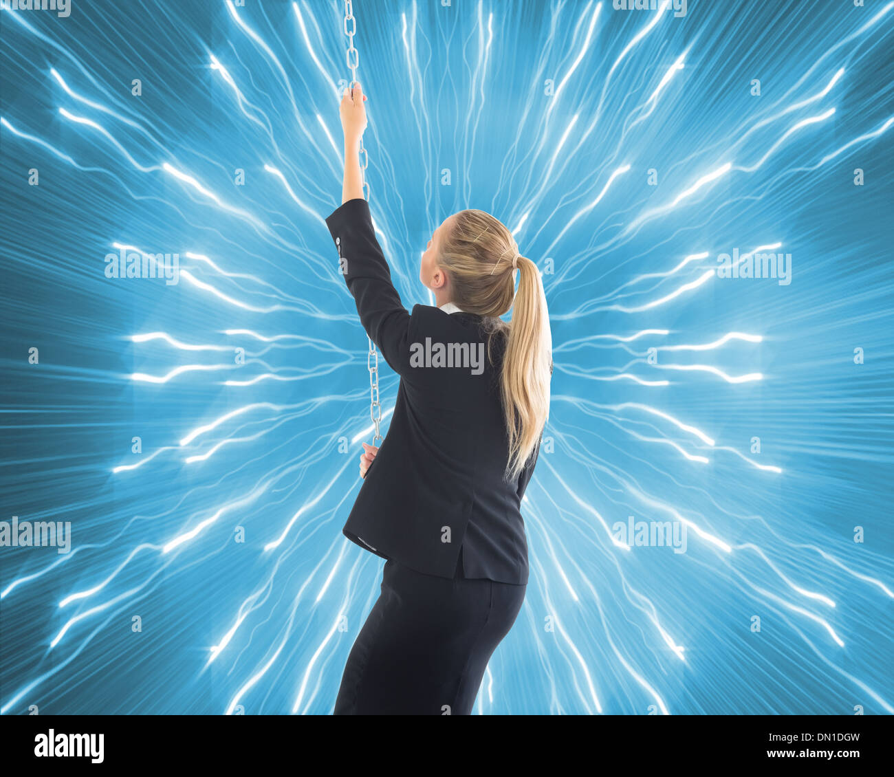 Composite image of blonde businesswoman pulling a chain Stock Photo - Alamy