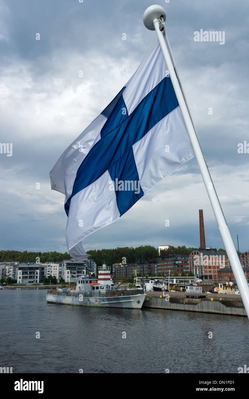 Finnish state flag. In the background the city of Lahti on Lake ...