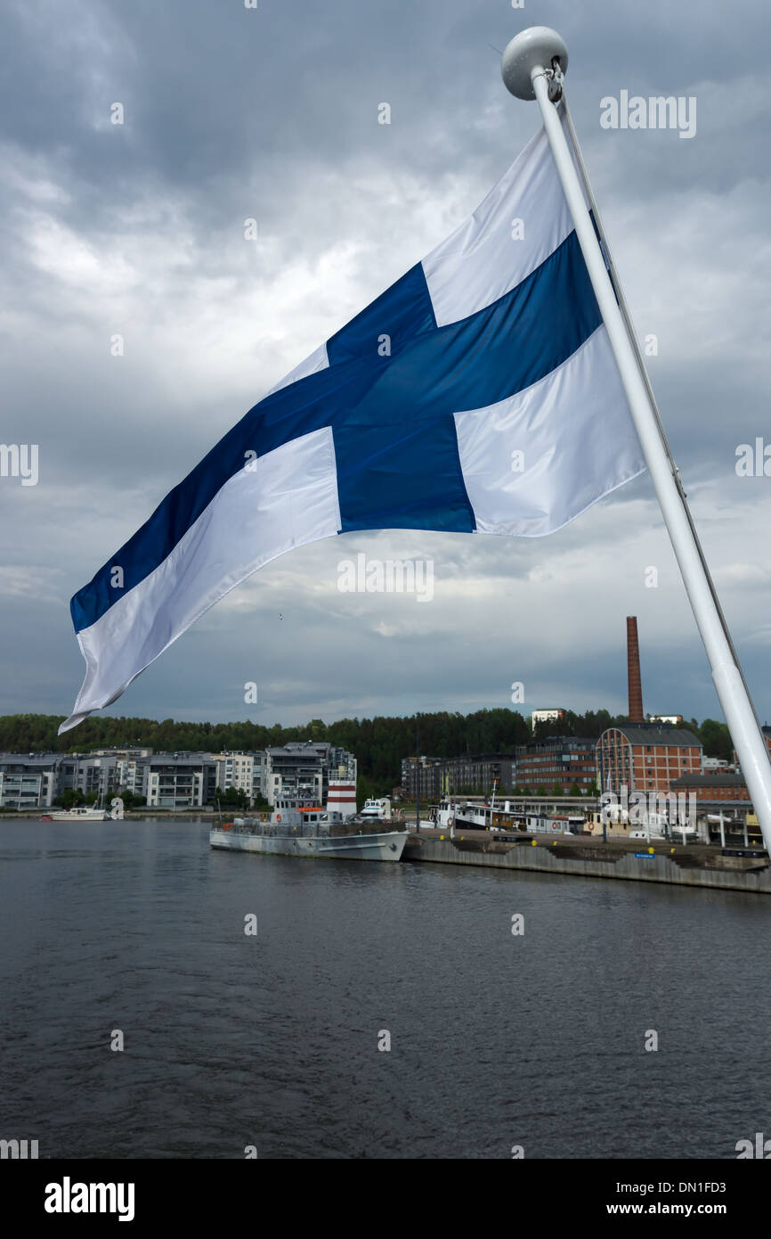 Finnish state flag. In the background the city of Lahti on Lake ...
