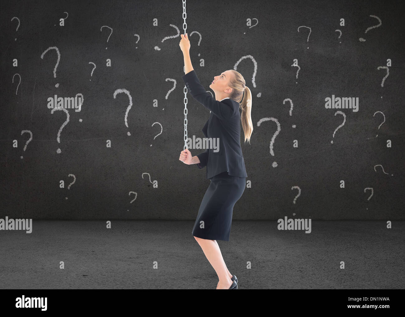 Composite image of blonde businesswoman pulling a chain Stock Photo - Alamy