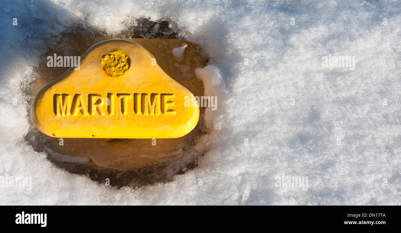 Yellow maritime bollard in snow at winter Stock Photo - Alamy