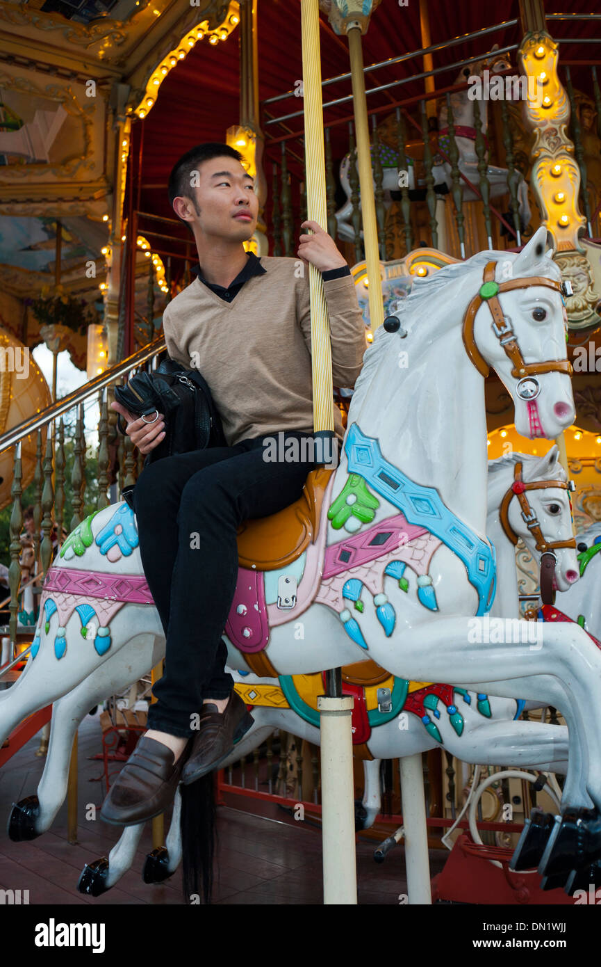 Paris, France, Young Chinese Man, on French Merry-go-Round, Mange Stock ...