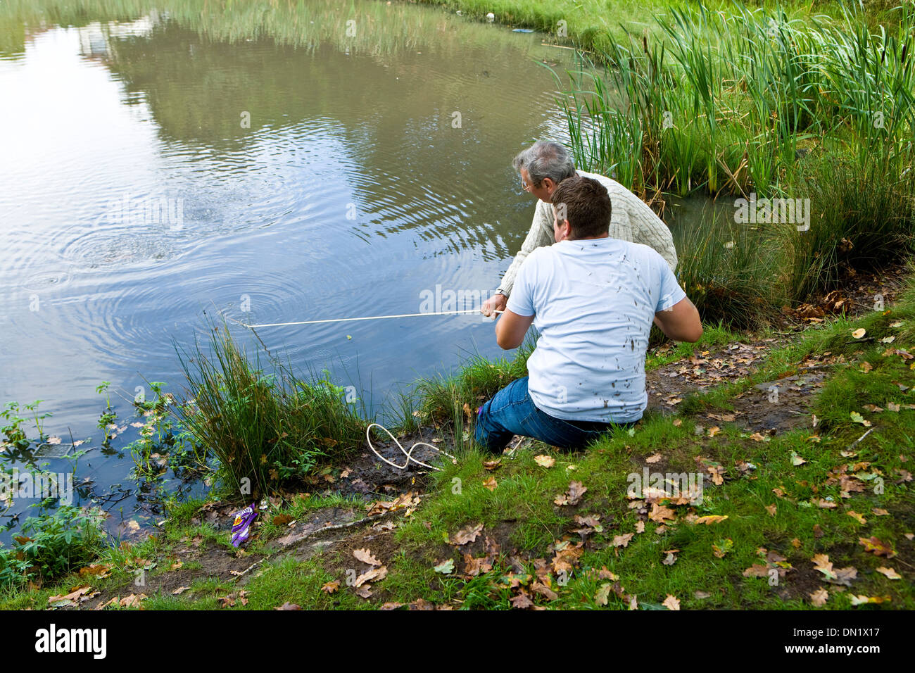 dredging rubbish out of a pond Stock Photo - Alamy