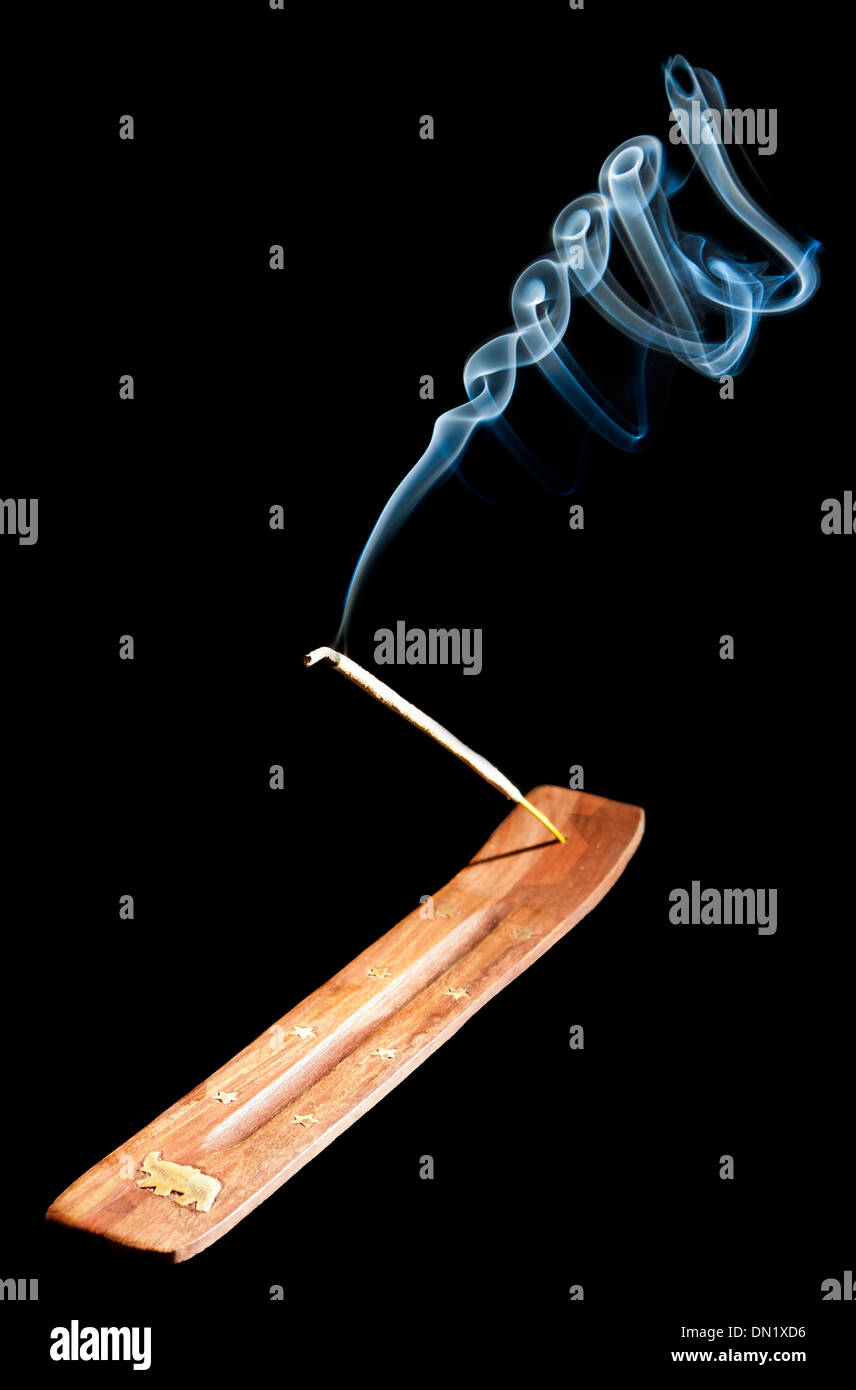 Smoking wooden incense isolated to black background Stock Photo - Alamy