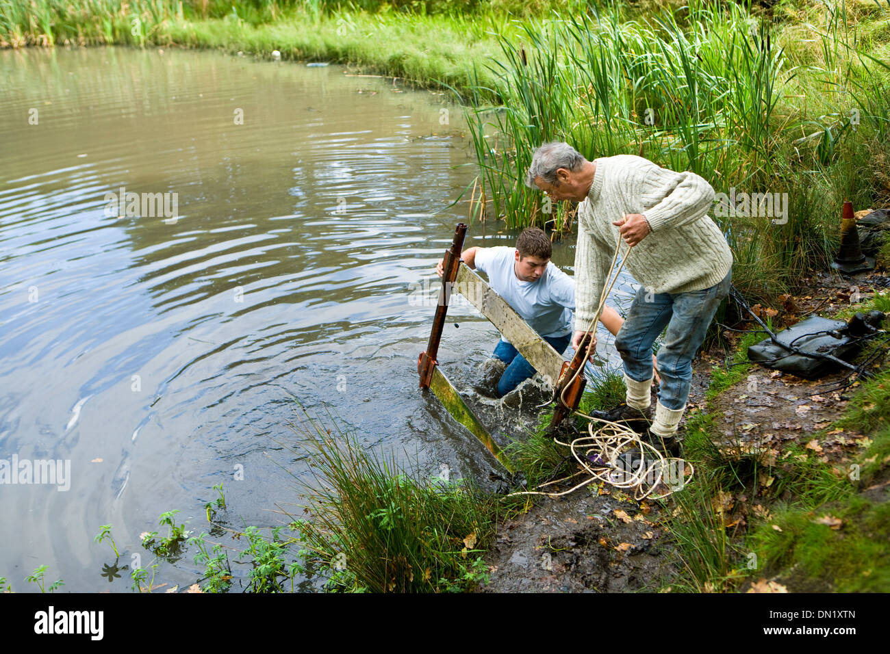 removing rubbish from a pond Stock Photo - Alamy