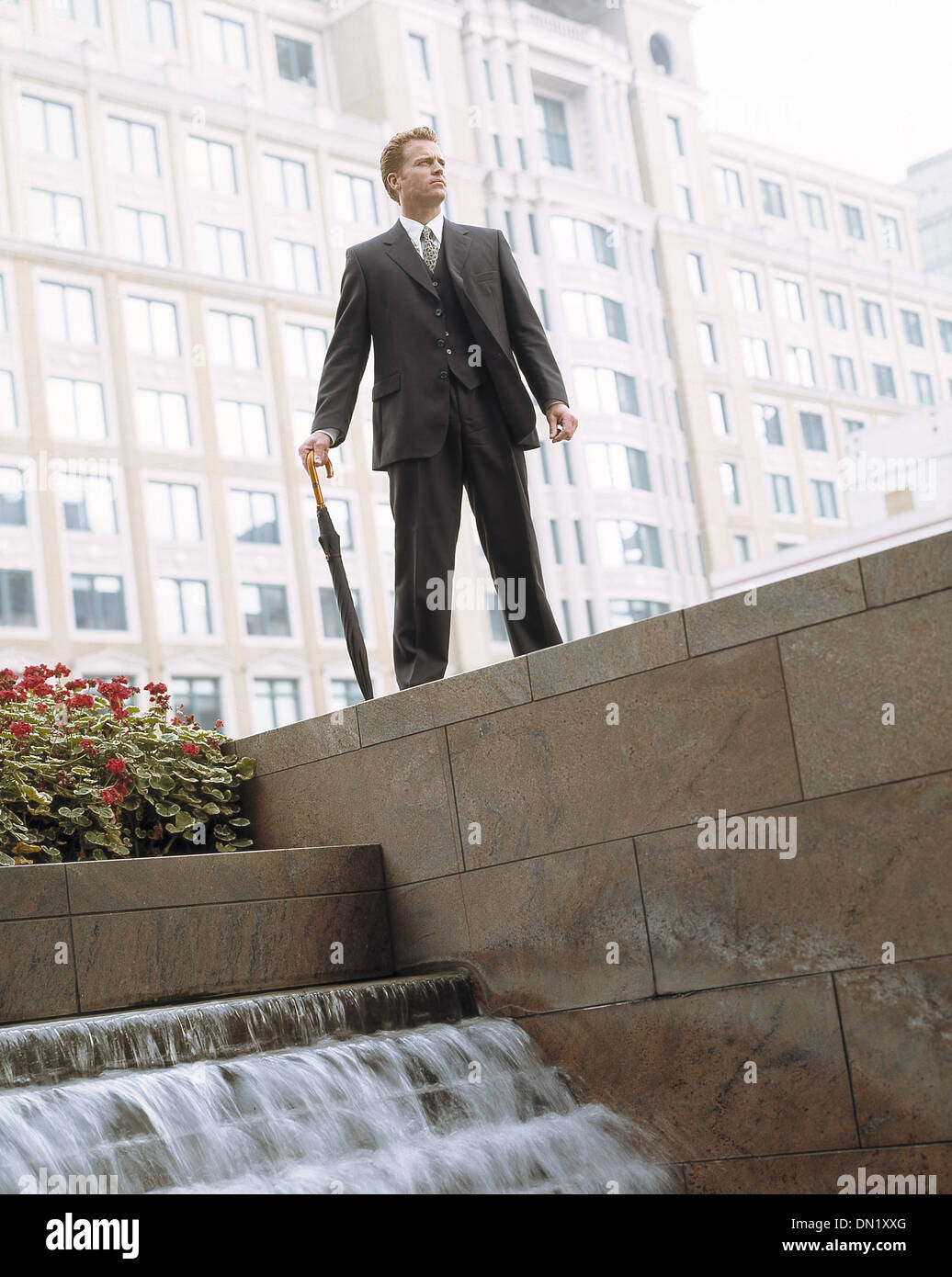 Man standing by London Waterfeature Stock Photo - Alamy