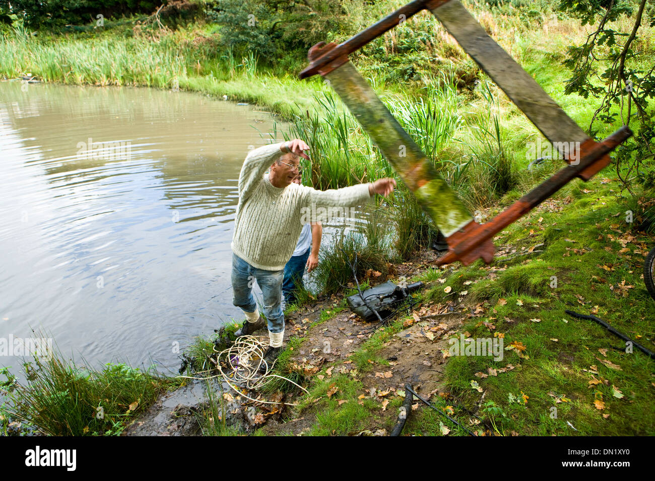 removing rubbish from a pond Stock Photo - Alamy