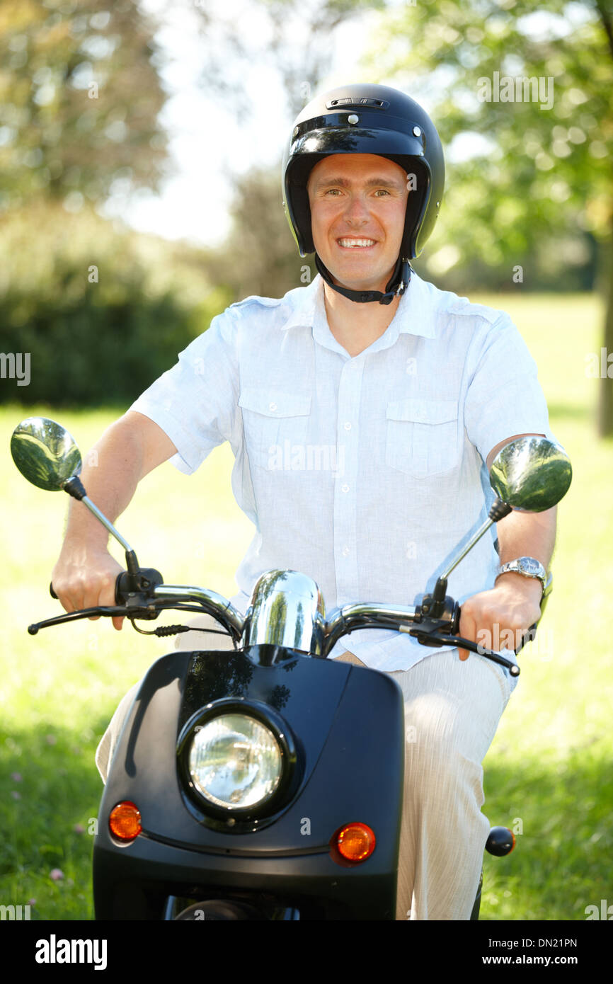 Man ride retro motorbike scooter Stock Photo - Alamy