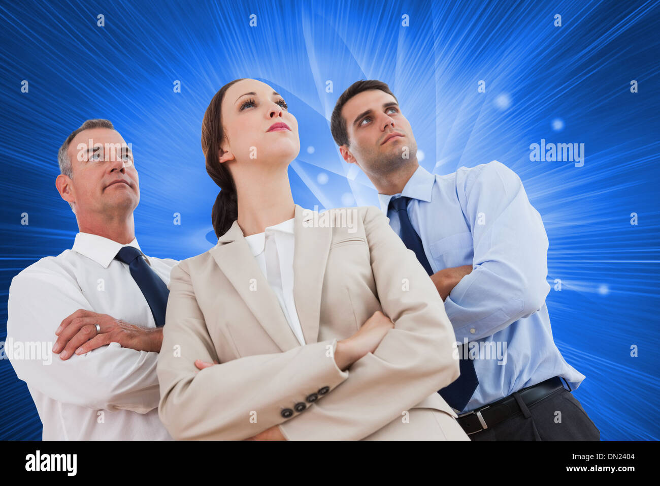 Composite image of serious work team posing together looking away Stock ...