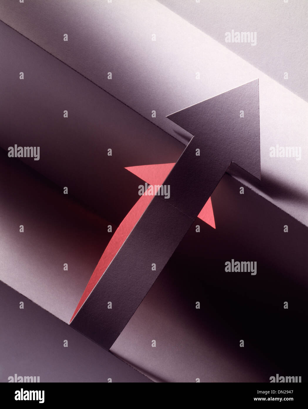 A paper arrow standing proud of the paper from which it was cut, with ...