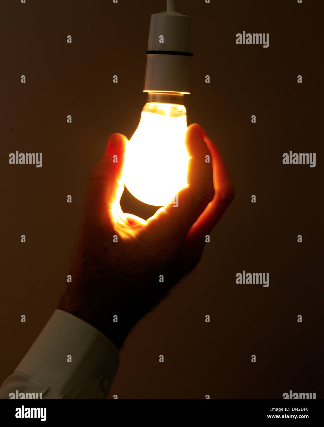 Hand Changing a lightbulb Stock Photo - Alamy