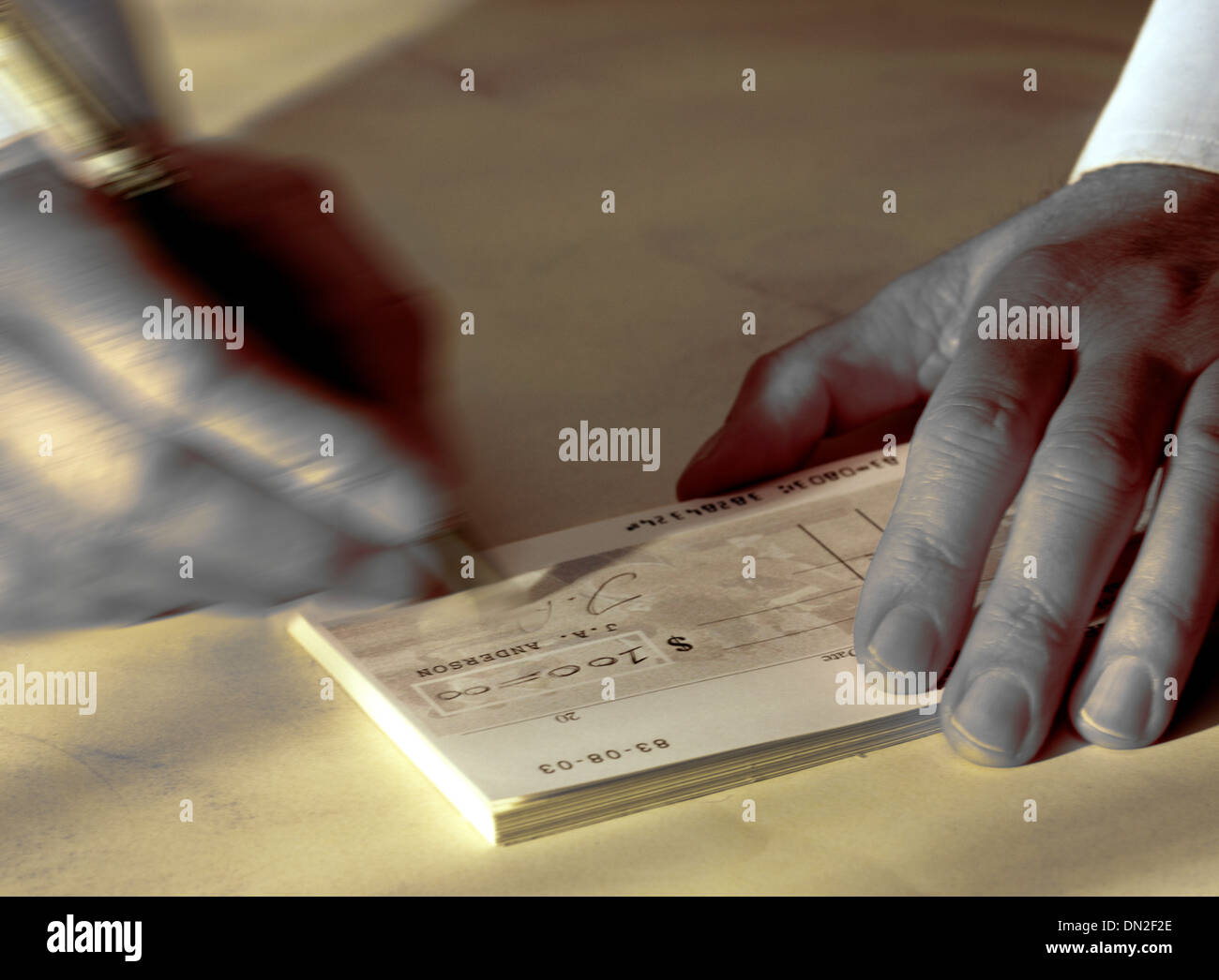 Man writing a cheque Stock Photo - Alamy