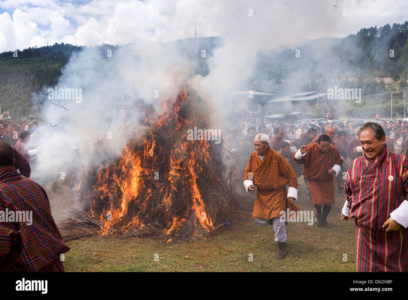 Bhutan, Thangbi Lhakang, Mewang, fire blessing ceremony, men running ...