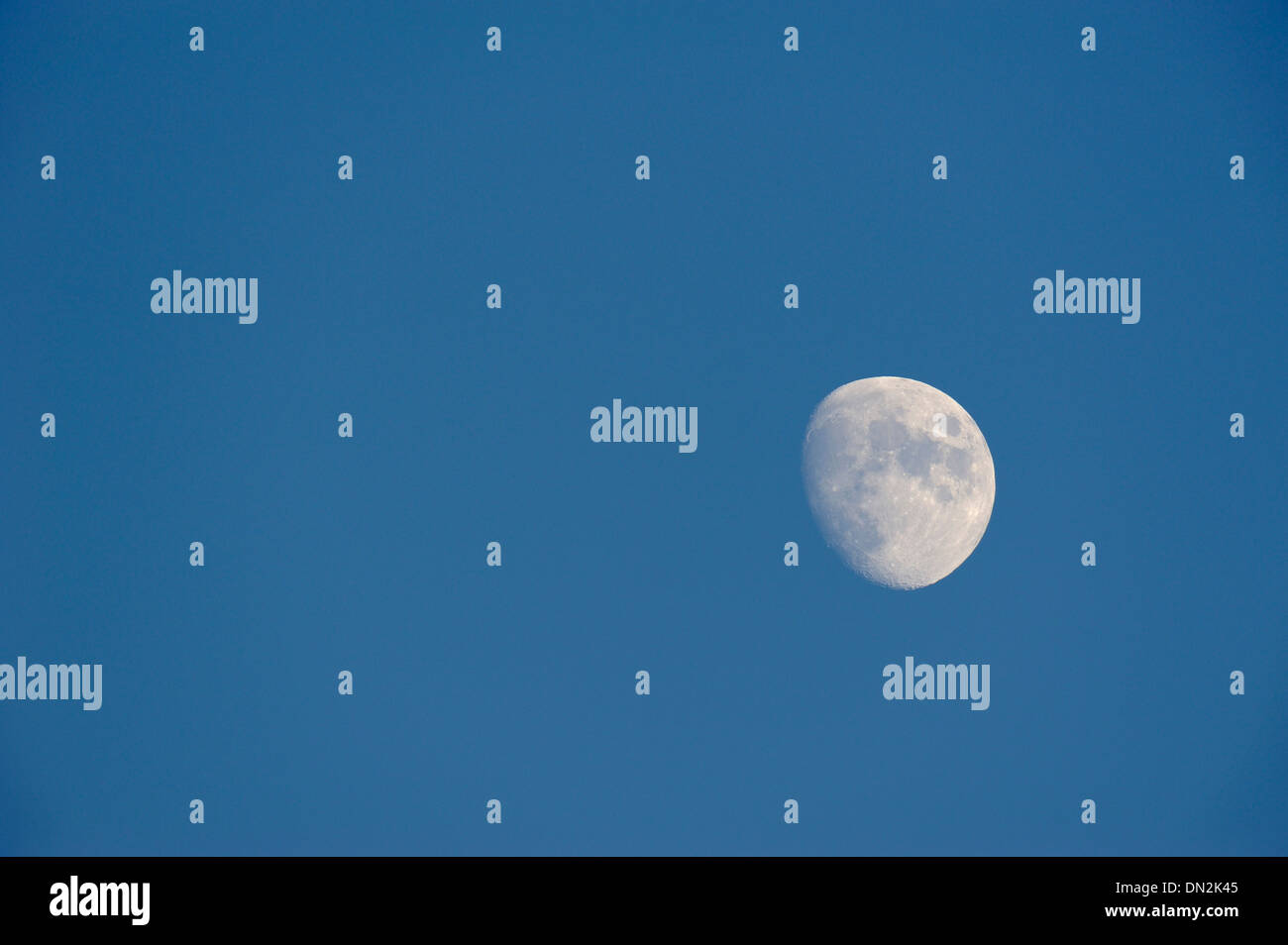 almost full moon at blue sky Stock Photo - Alamy
