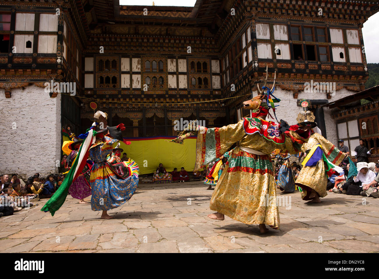 Bhutan, Thangbi Mani Lhakang Tsechu Festival, masked ging dancers in monastery courtyard Stock ...