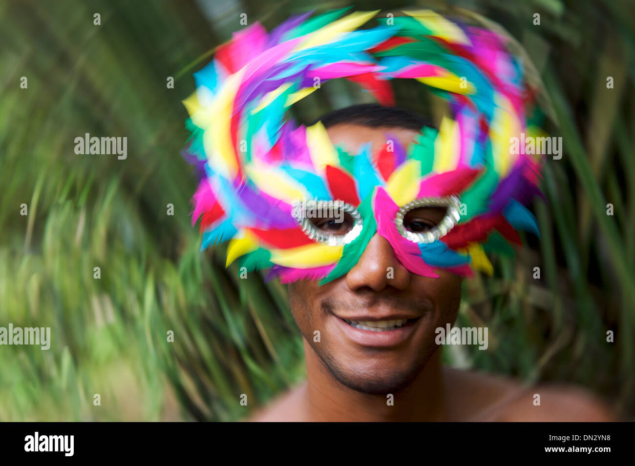 Brazil Carnival scene features smiling Brazilian man in colorful mask ...