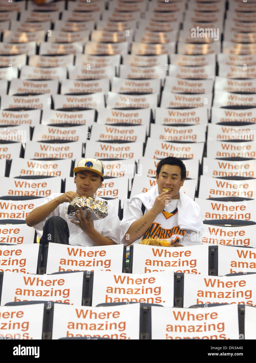 Richard Nguyen, left, and Ryan Owyang, right, munch on a pre-game hot ...